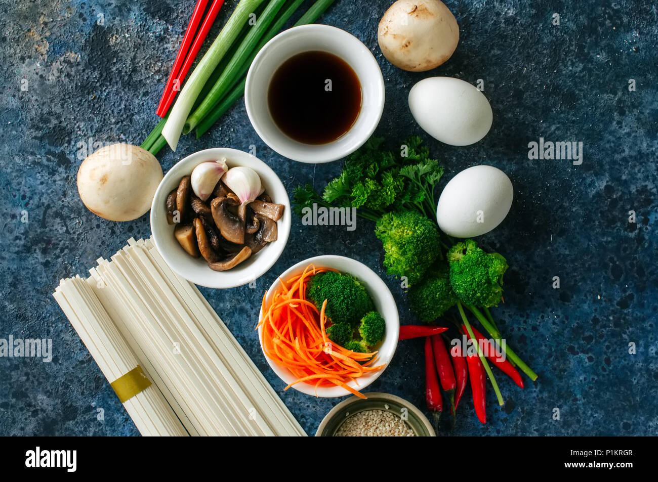 Ingredients of asian cuisine noodles eggs vegetables spices sauce herbs ...