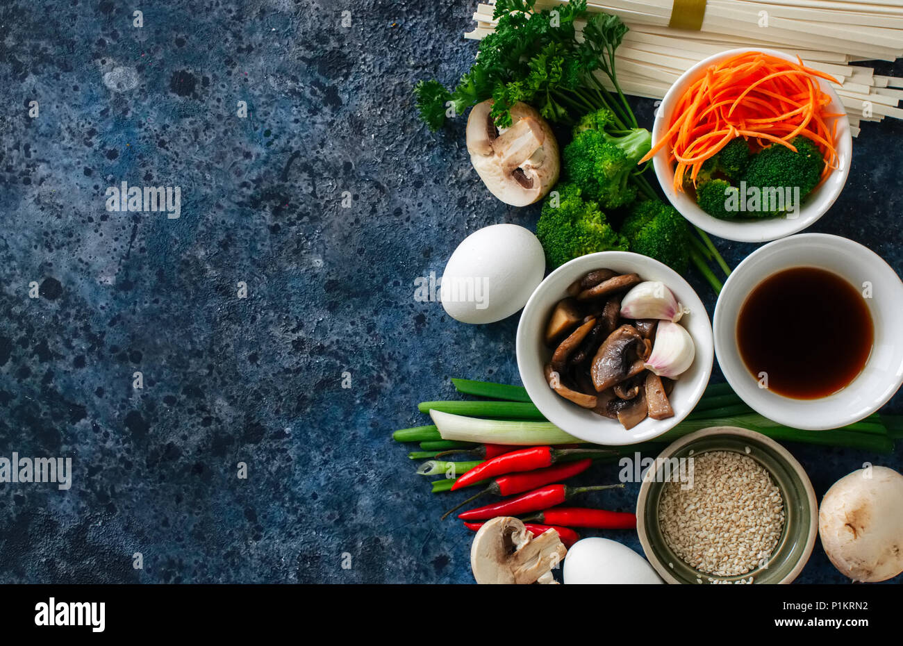 Ingredients of asian cuisine noodles eggs vegetables spices sauce herbs ...