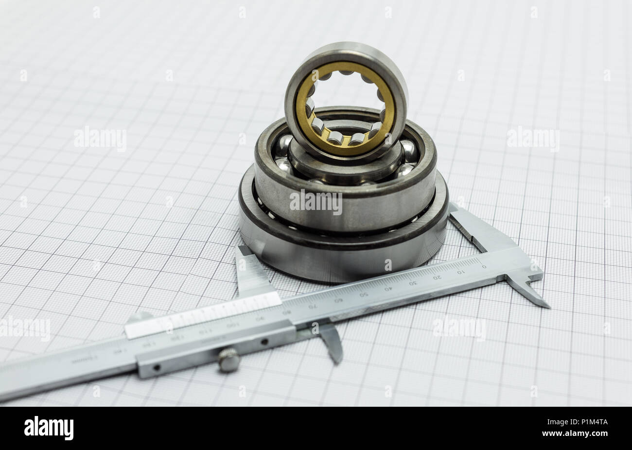 Vernier caliper lying on drafting paper with bearings Stock Photo - Alamy