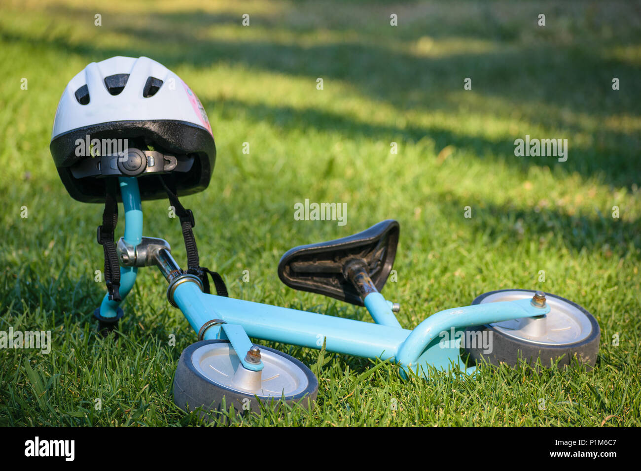 Bicycle without pedals for young kids learning balance laying on grass ...