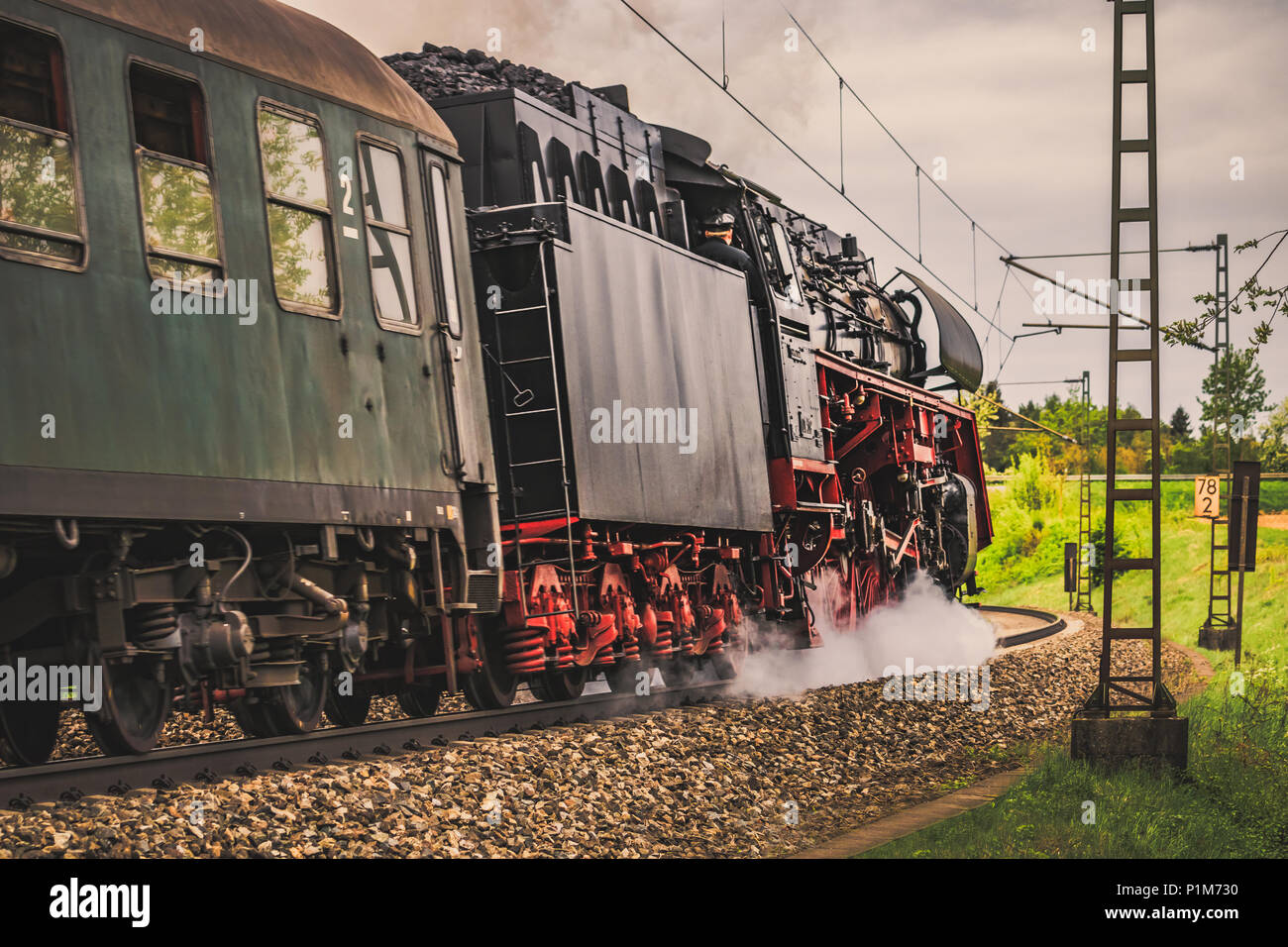 Steam locomotive at full throttle in the countryside Stock Photo - Alamy