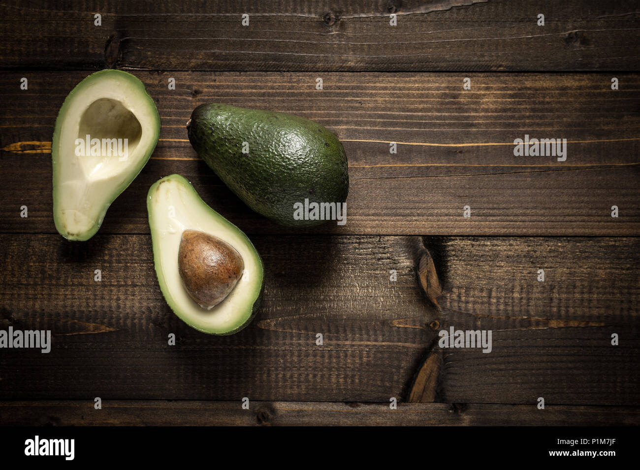 Avocado on Dark Wooden Background as Healthy Food Concept Stock Photo ...