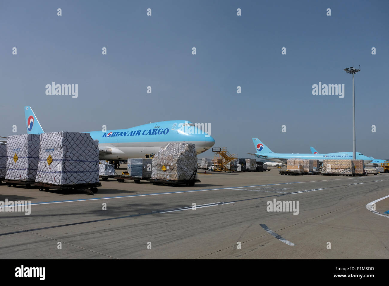 Cargo sits on the tarmac as a Korean Air Lines Co. freight plane taxies ...
