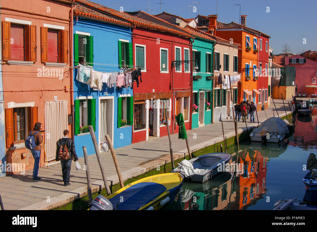 Colourful houses and bustling and busy canals on the fishing village of Burano in the Venice ...