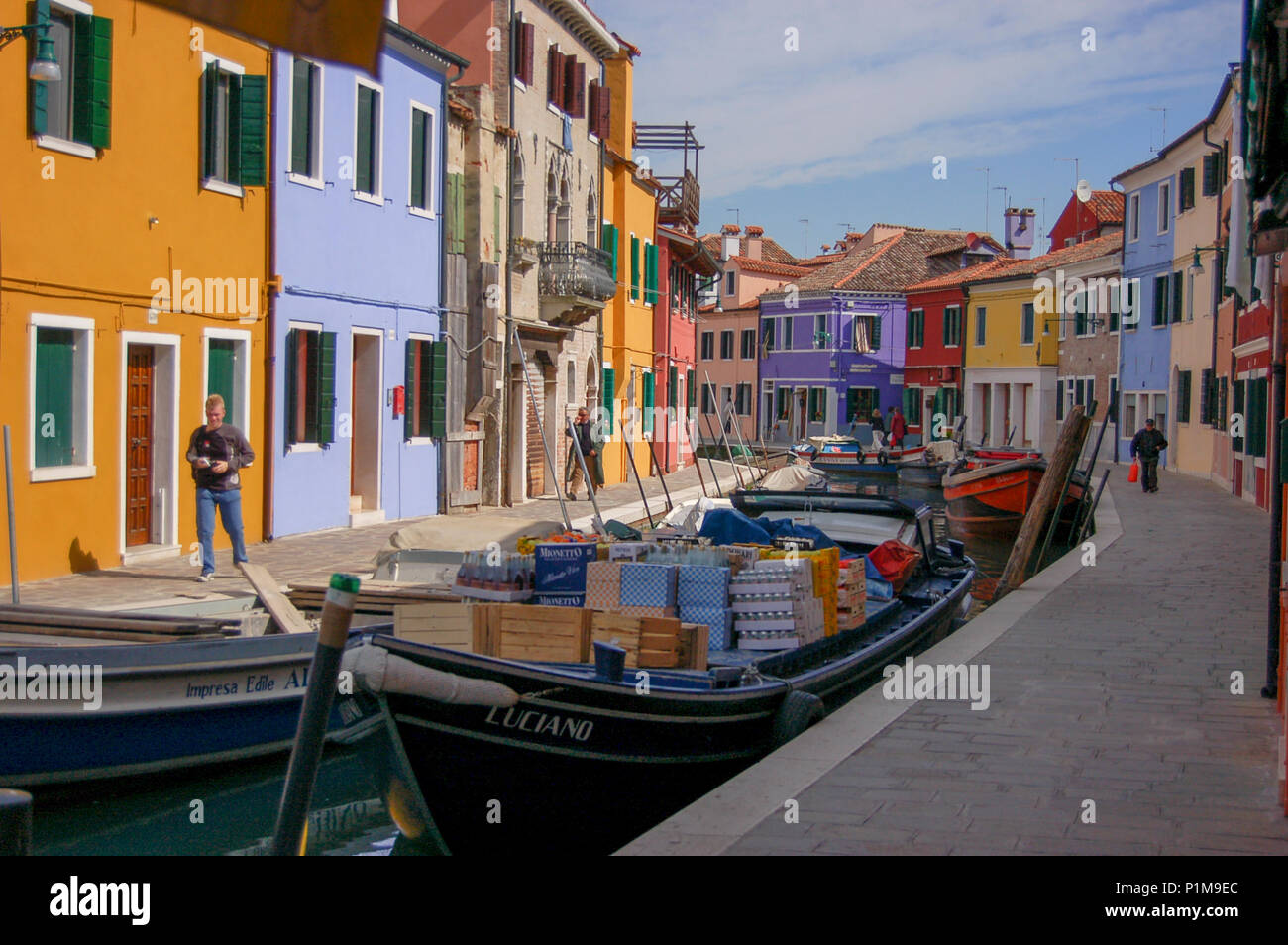 Colourful houses and bustling and busy canals on the fishing village of Burano in the Venice ...