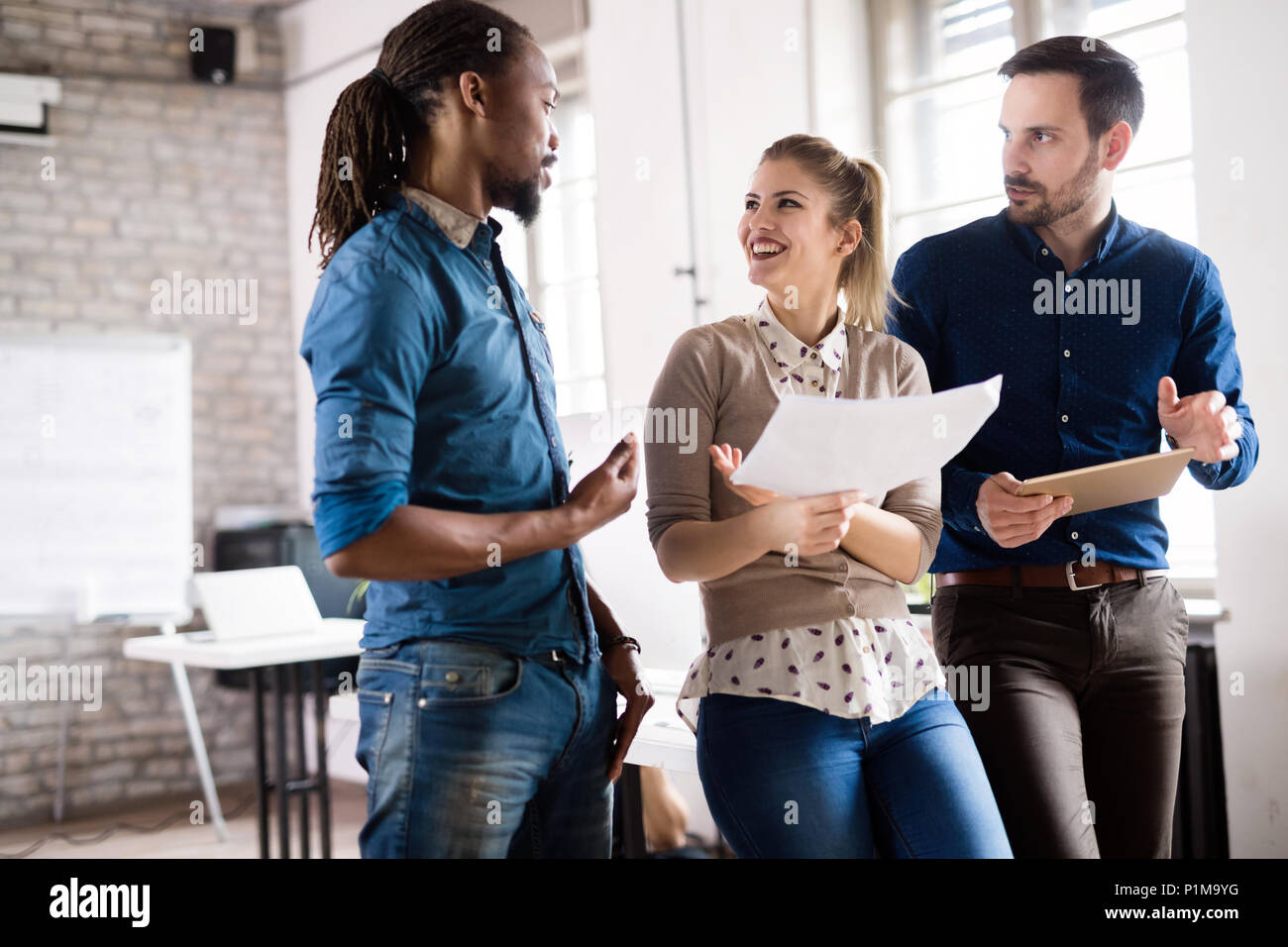 Smiling diverse businesspeople having discussion hi-res stock ...