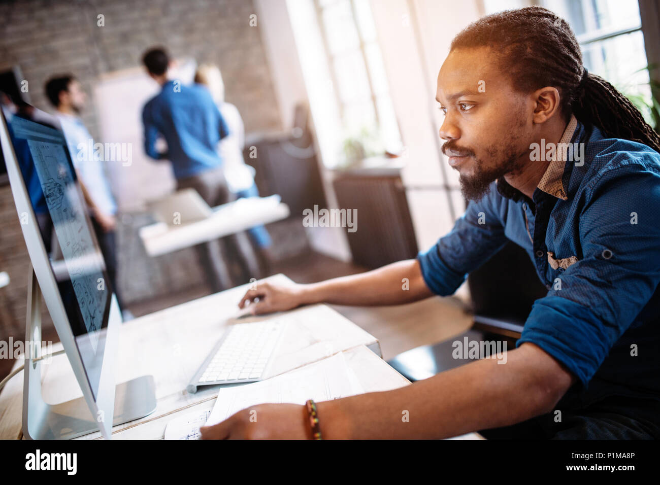 Young architect working on computer in office Stock Photo - Alamy