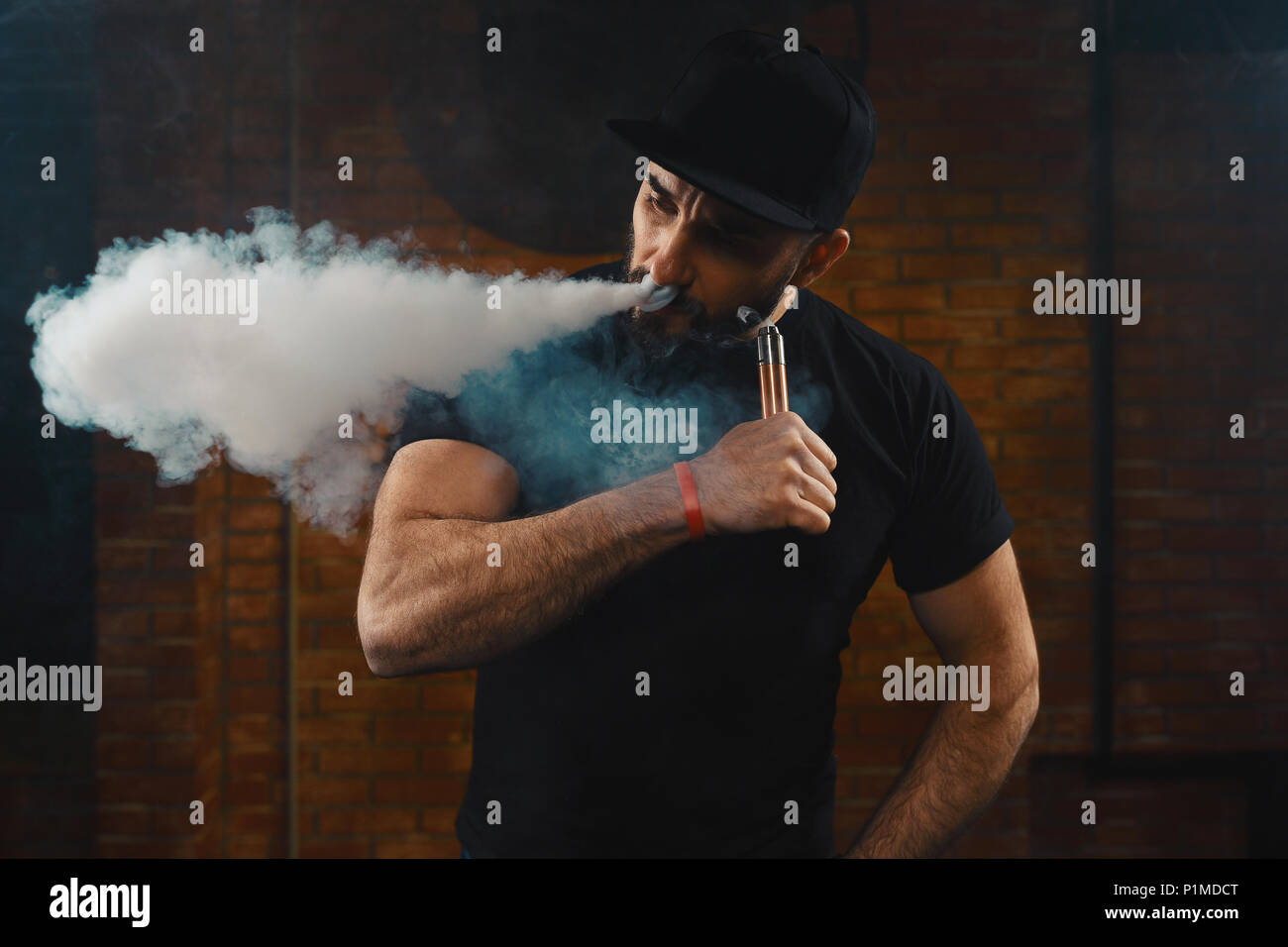 Man vaping an electronic cigarette Stock Photo - Alamy