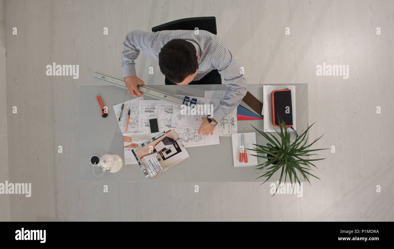 Architect is working on plan of building with a ruler. Top view Stock ...