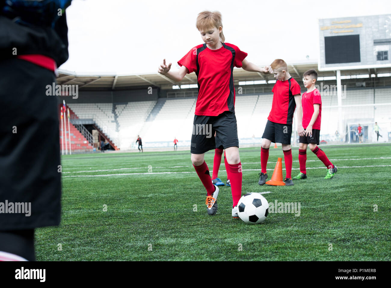 Teenage Boy Practicing Football with Team Stock Photo - Alamy