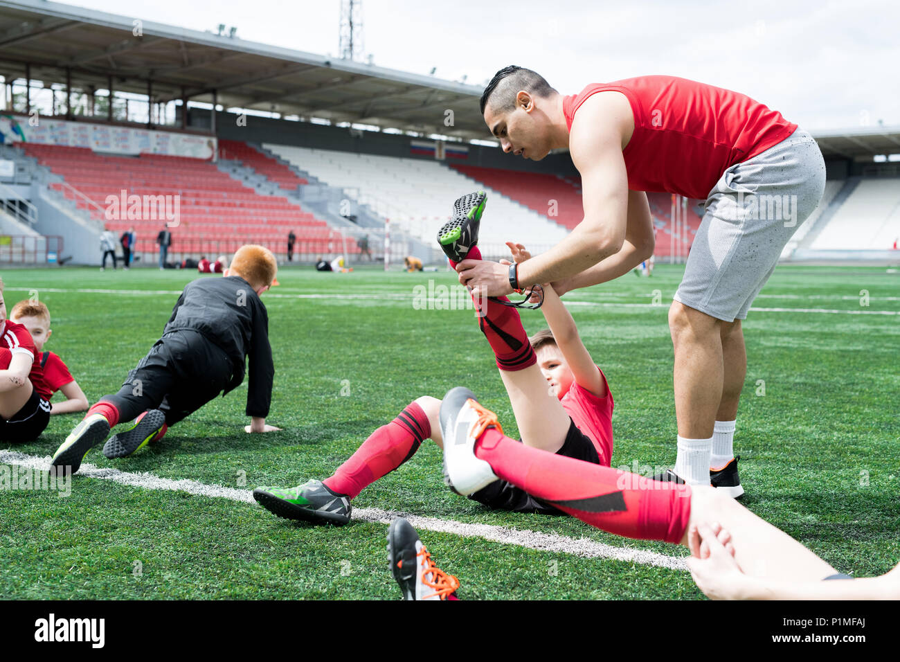 Junior Football Team Stretching at Practice Stock Photo - Alamy