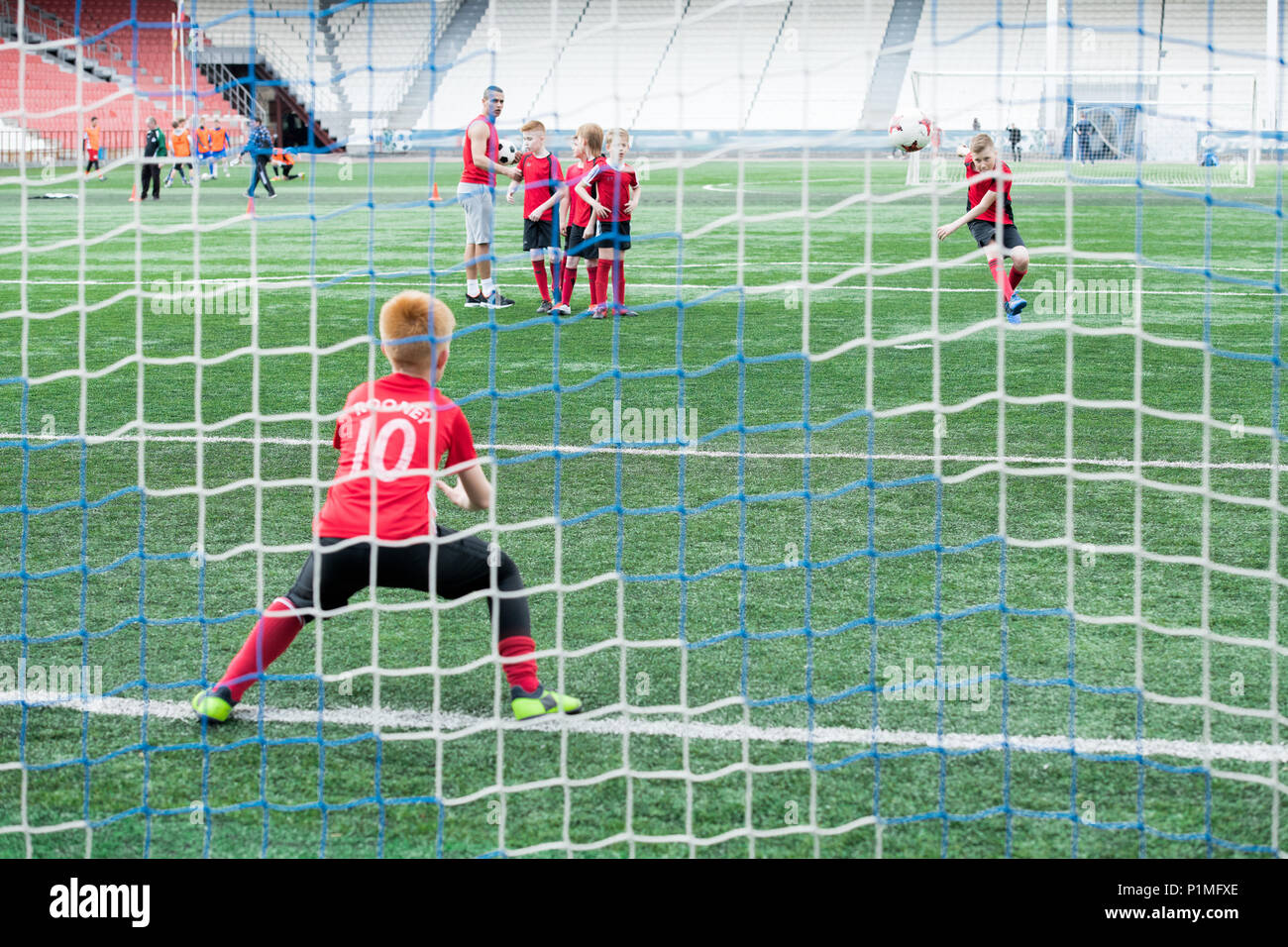 Boy Defending Gates in Football Match Stock Photo - Alamy