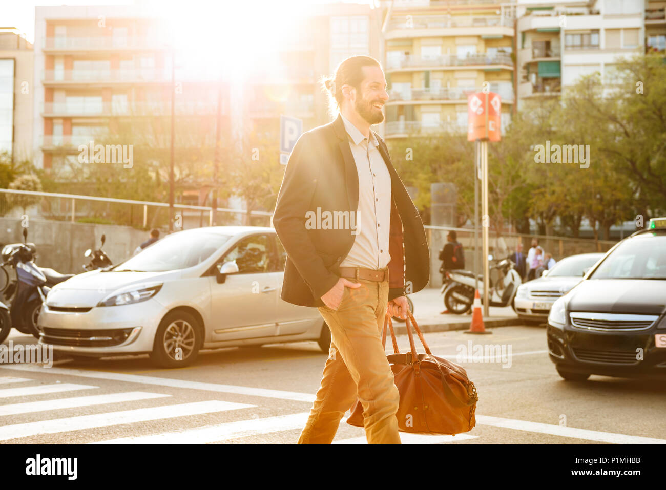 Image of satisfied businessman in stylish formal wear walking through ...