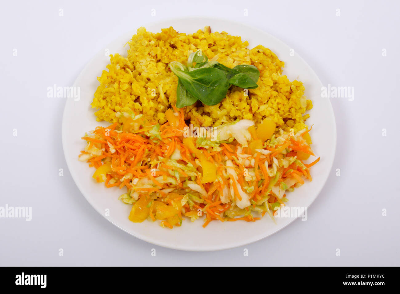 Baked Bulgar with cauliflower and vegetable salad on a white background ...