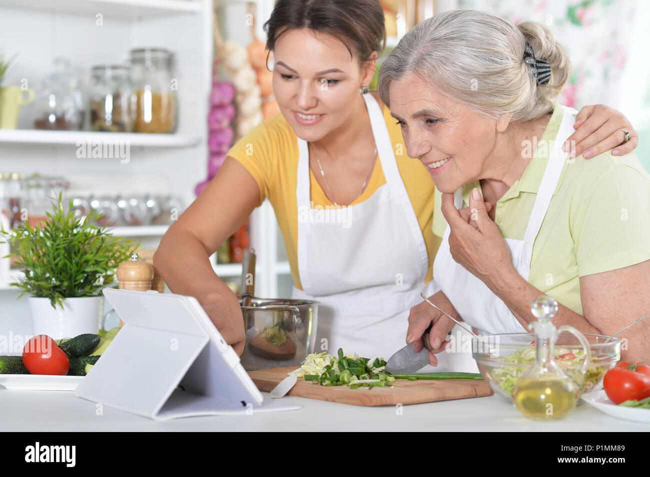 Mother and daughter cooking together Stock Photo - Alamy