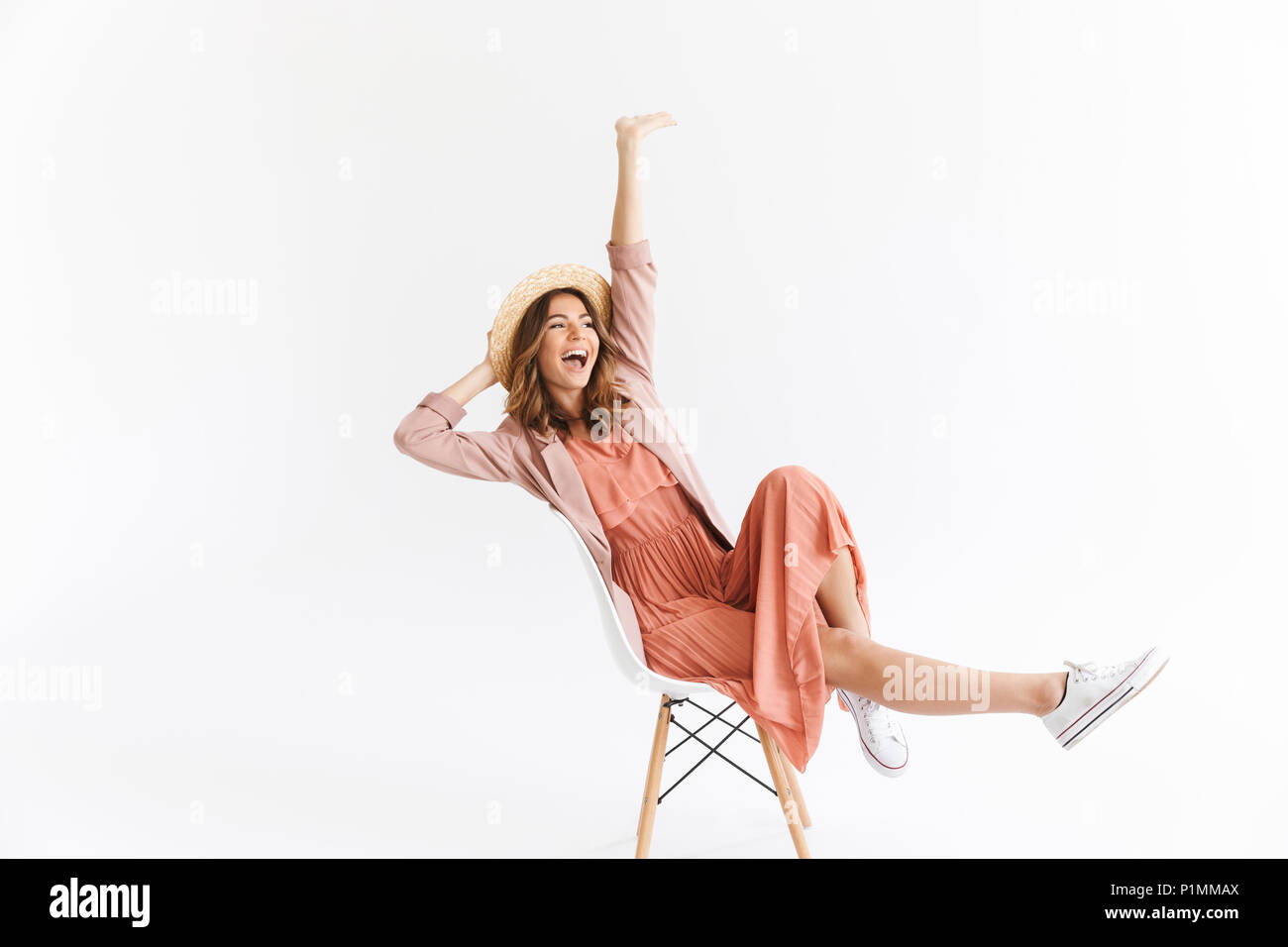 Image of young amazing emotional beautiful woman sitting isolated over ...