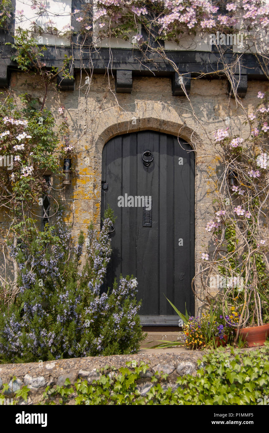 Country cottage half timbered and thatched with beautiful gardens of ...