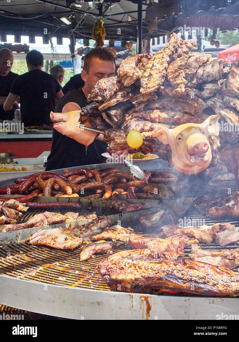 Hispanic cook cooking Pork Spare Ribs and others meats cuts on a ...