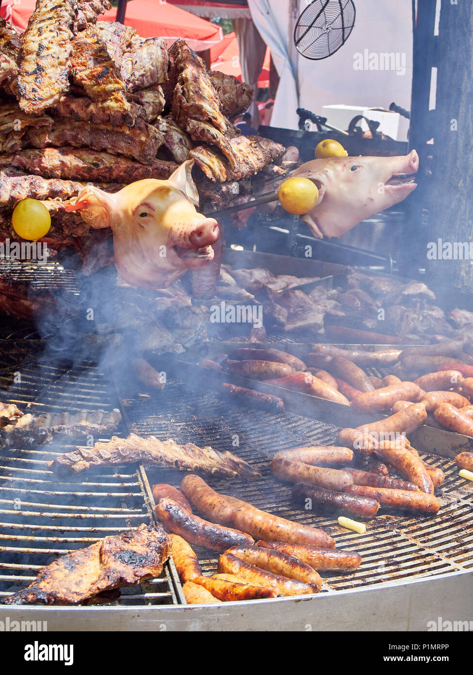 Sausages, Pork Spare Ribs and others meats cuts on a charcoal bbq in a ...