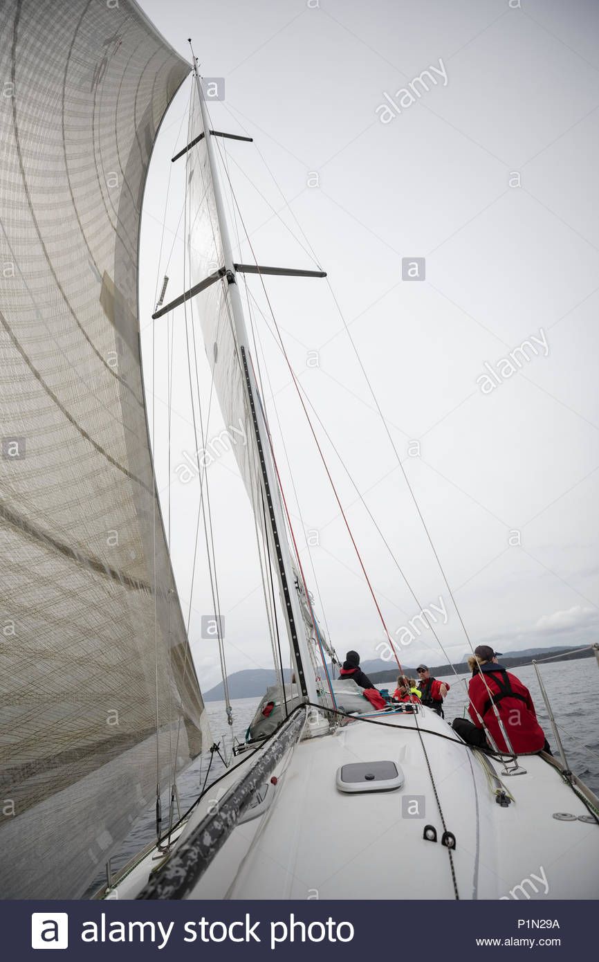 Man sitting on deck of a sailing boat hi-res stock photography and ...