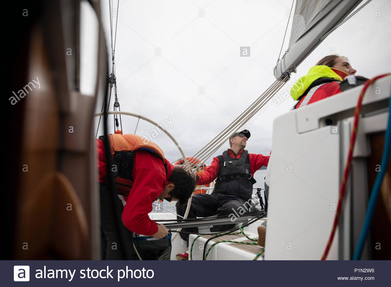 Man adjusting rigging on sailboat hi-res stock photography and images ...