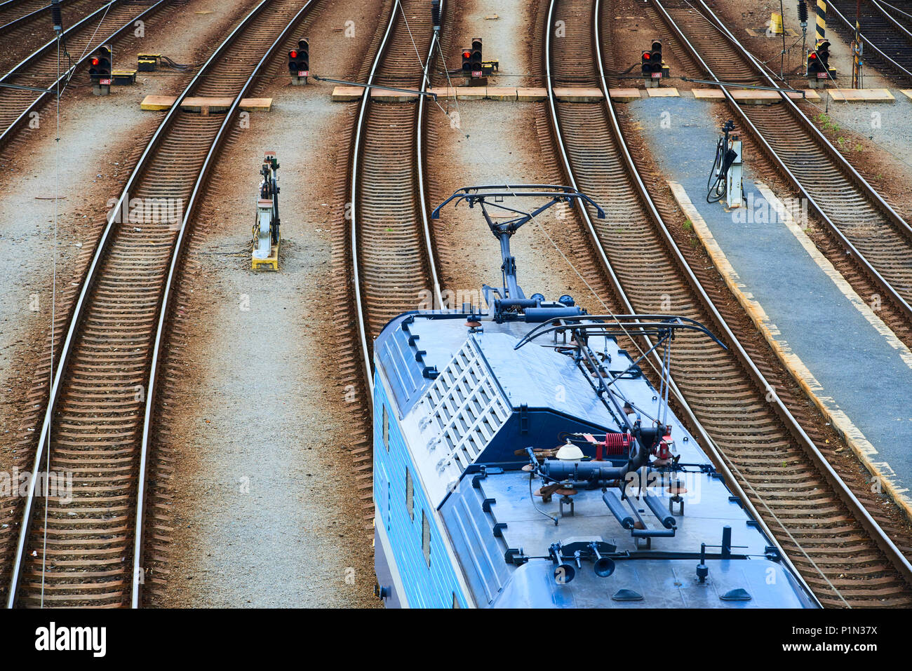 Electric locomotive and a train standing on the railroad tracks Stock ...
