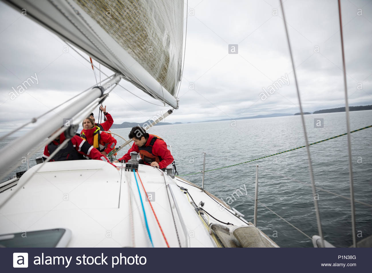 Sailing team training on sailboat on ocean Stock Photo - Alamy