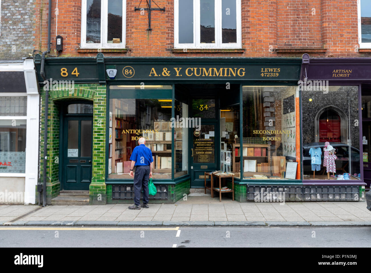 Man looking the A & Y. Cumming Antique books in Lewes, East Sussex ...