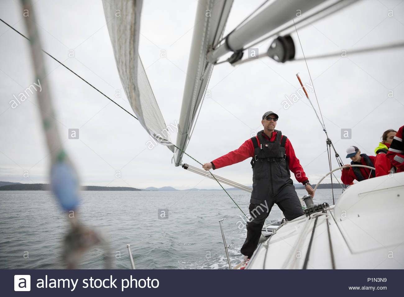 Sailing team training on sailboat on ocean Stock Photo - Alamy