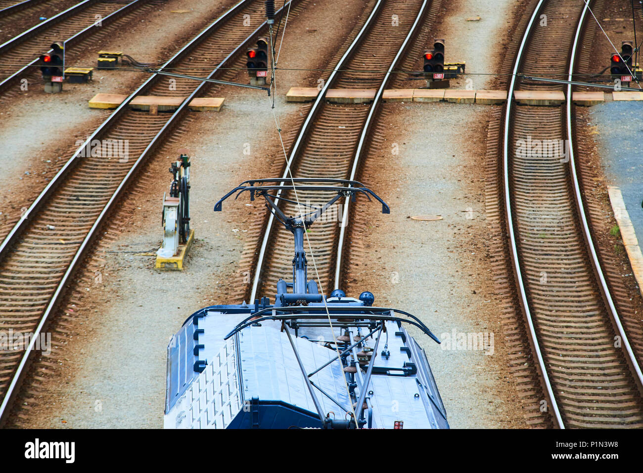 Electric locomotive and a train standing on the railroad tracks Stock ...
