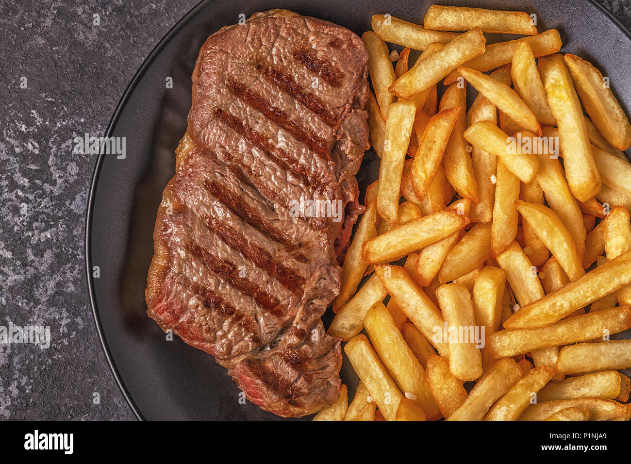 Beef barbecue steak with french fries, top view Stock Photo - Alamy