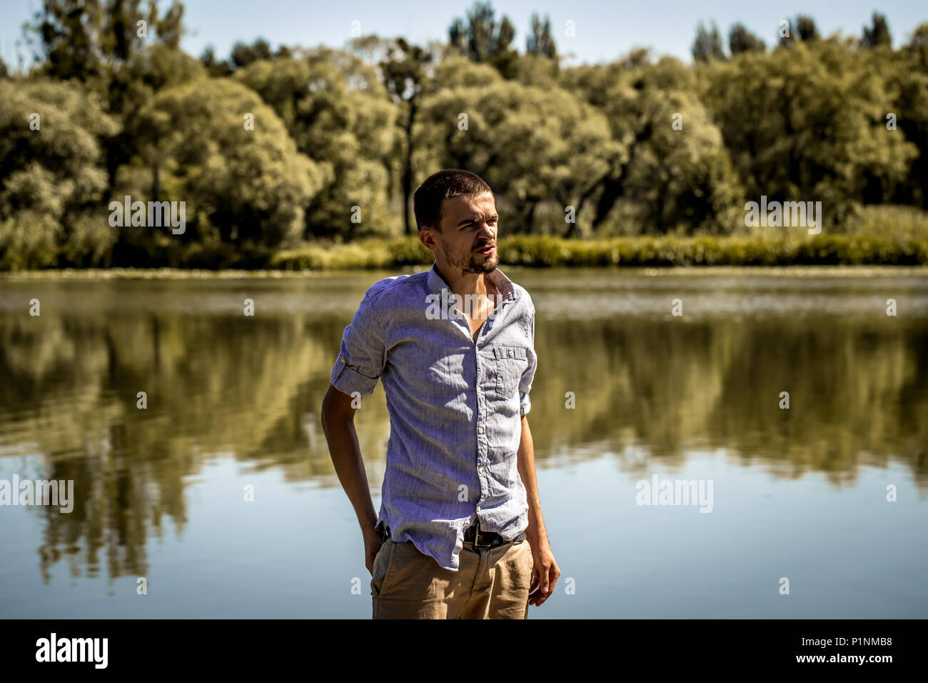 Young guy on background lake hi-res stock photography and images - Alamy
