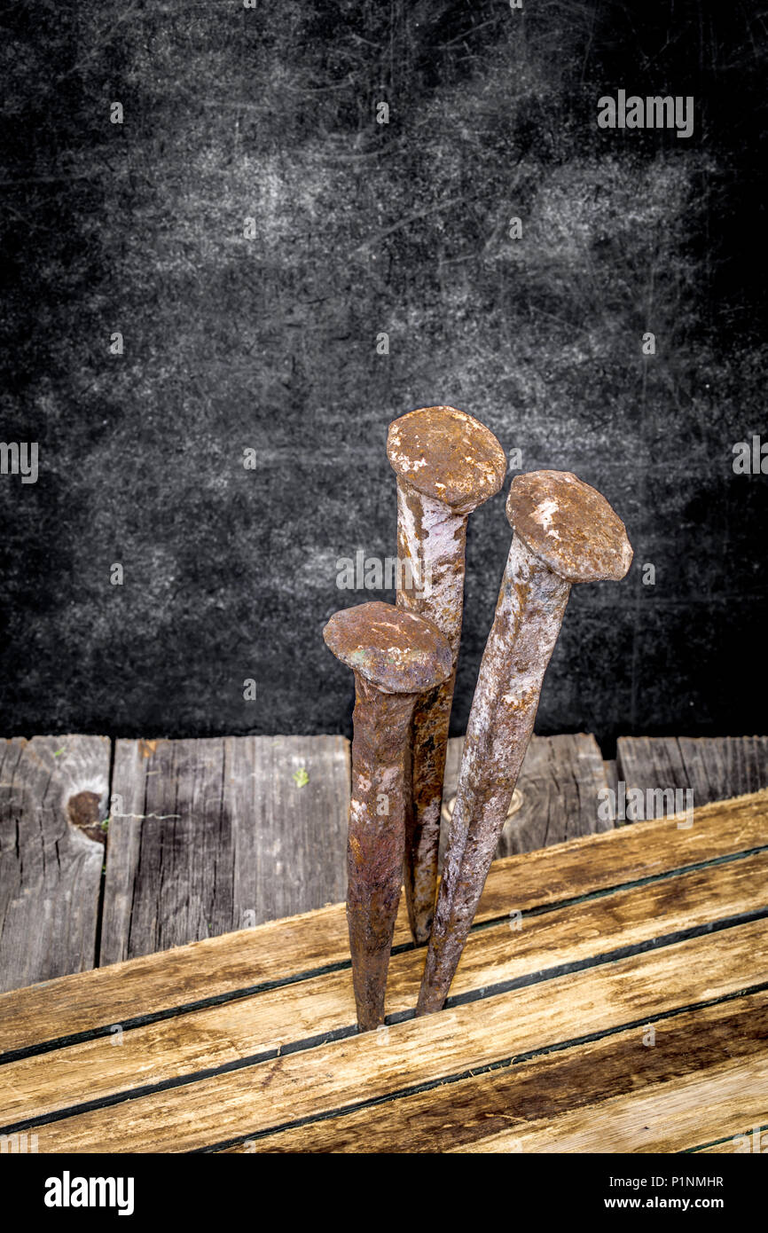very old large nails on a beautiful wooden background, rusty nails ...