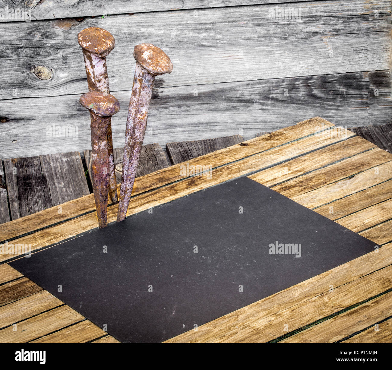 very old large nails on a beautiful wooden background, rusty nails ...