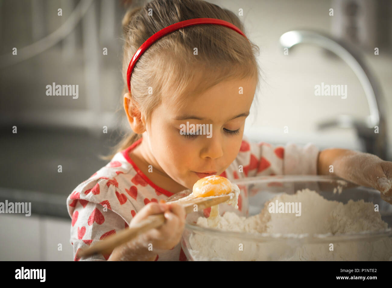 beautiful little girl Baker on kitchen with ingredients for baking ...