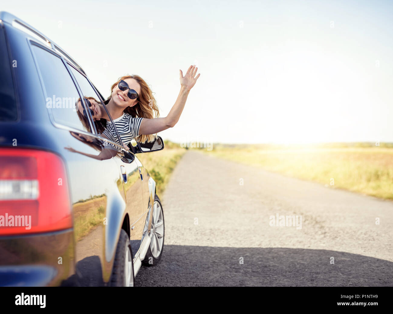 Person waving from car hi-res stock photography and images - Alamy