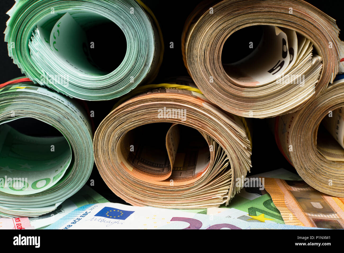 Rolled several thousand euro banknotes with rubbers background Stock ...