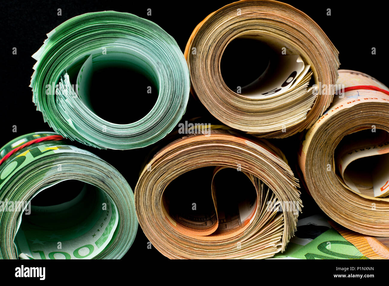 Rolled several thousand euro banknotes with rubbers background Stock ...