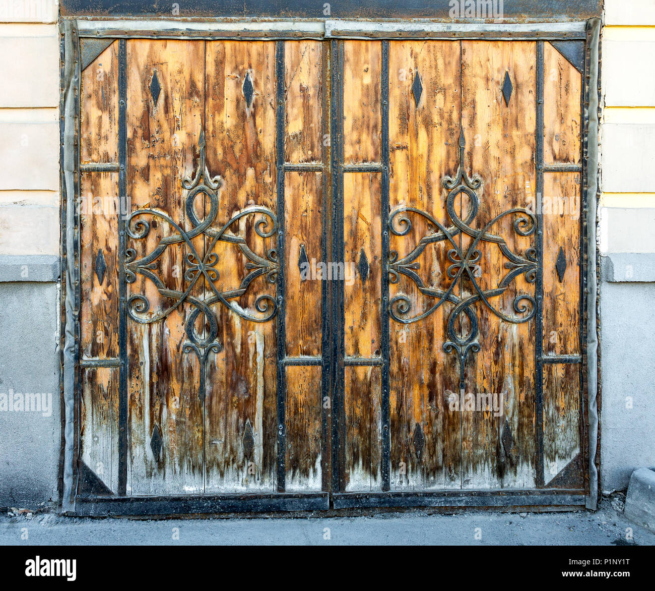 Old wooden gate with decorative iron patterns Stock Photo - Alamy