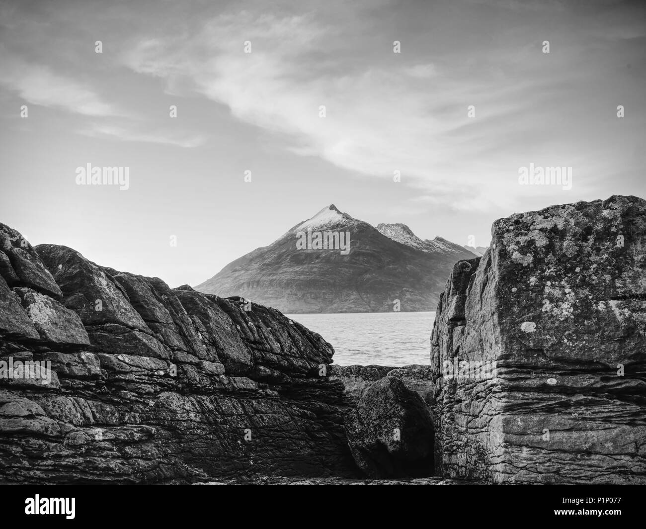 Evening at Loch Scavaig with Cuillins mountains in warm sunset light ...