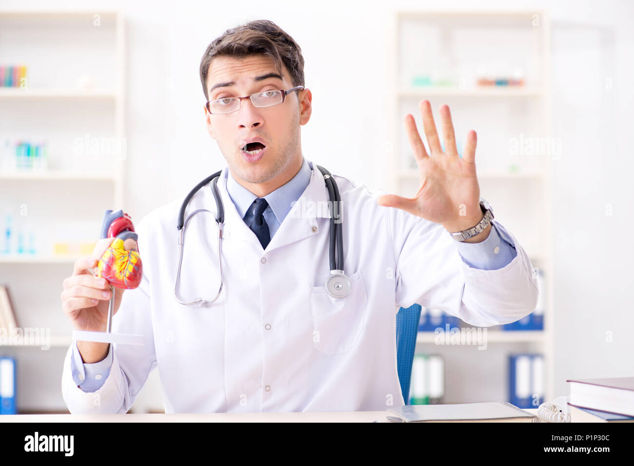 Doctor lecturer explaining the heart model Stock Photo - Alamy