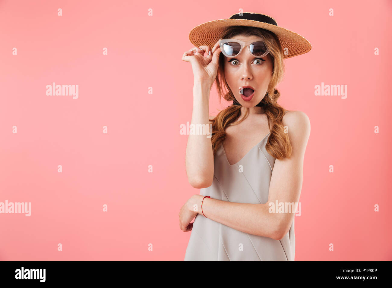 Shocked Brunette Woman Wearing In Dress And Hat Take Off Sunglasses