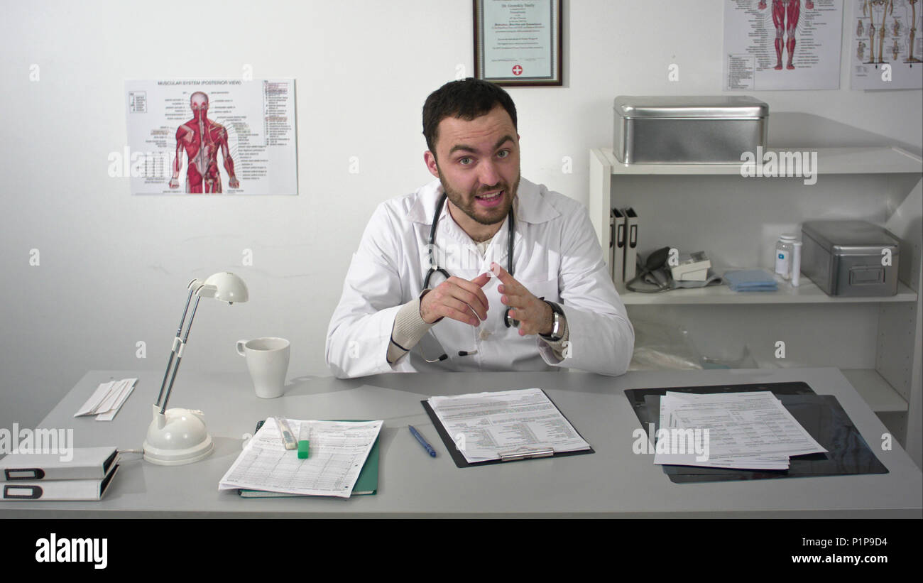 Male doctor talking camera explaining hi-res stock photography and ...