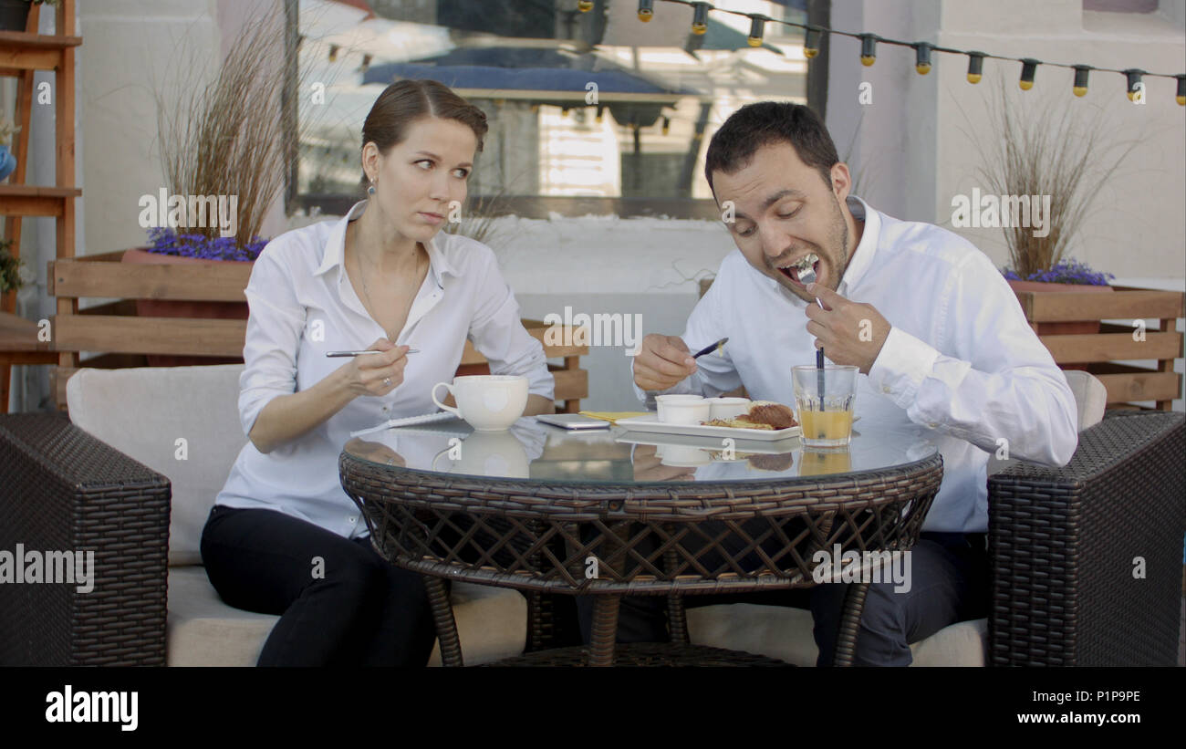 Businessman eating lunch discussing laptop hi-res stock photography and ...