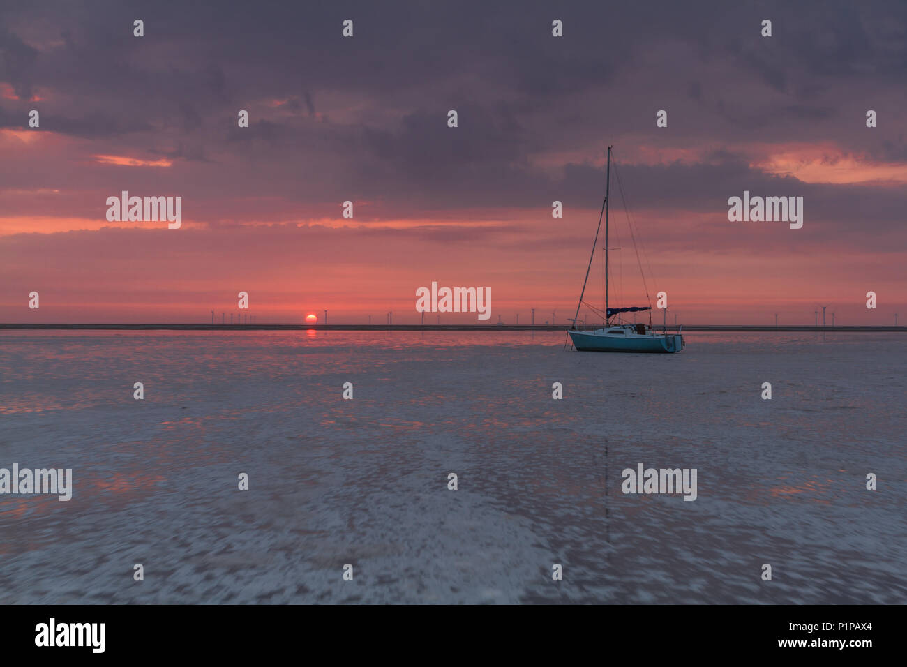 Sunset at Meols, Wirral, UK, with high tide and yachts Stock Photo - Alamy