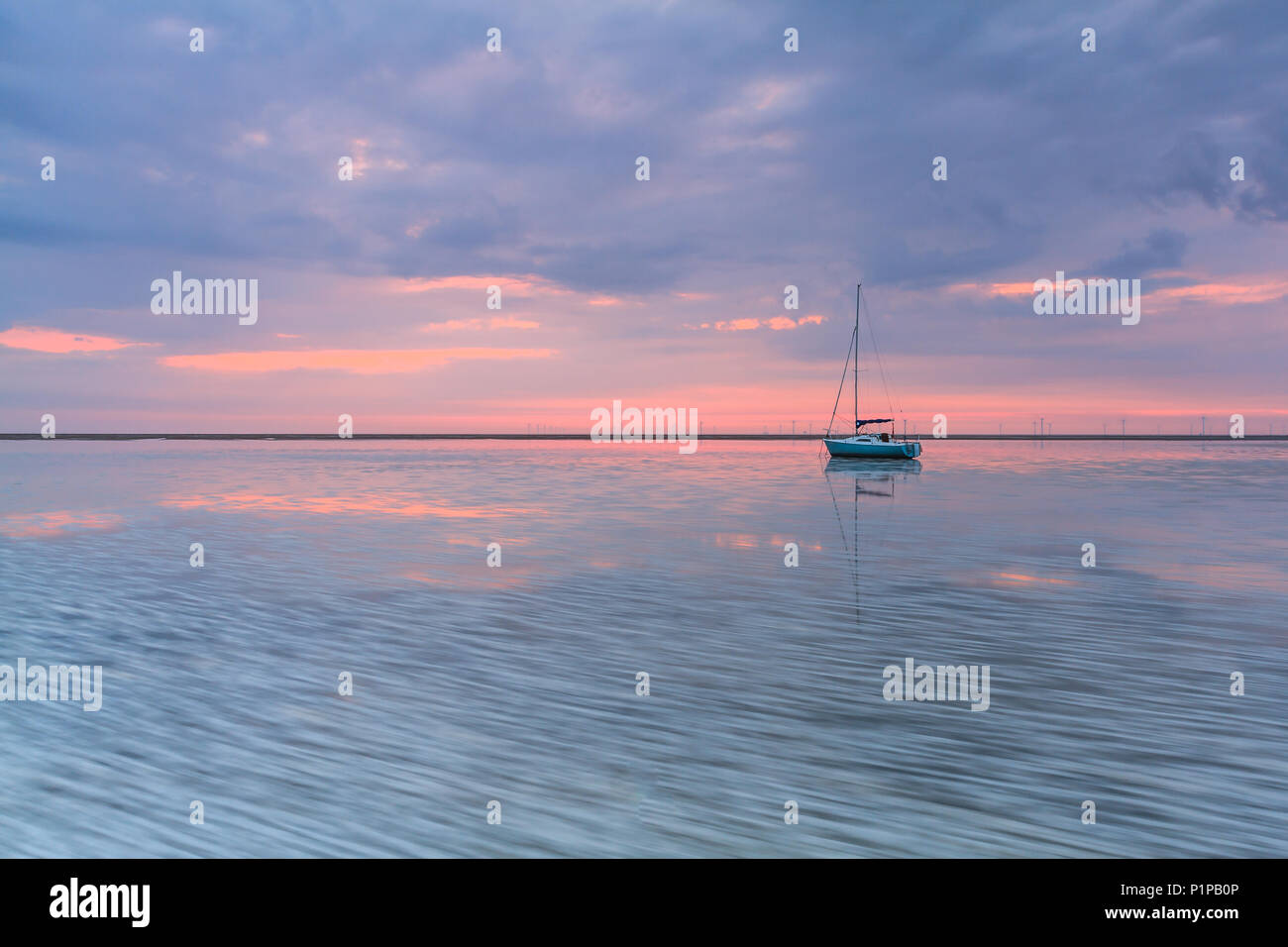 Sunset at Meols, Wirral, UK, with high tide and yachts Stock Photo - Alamy