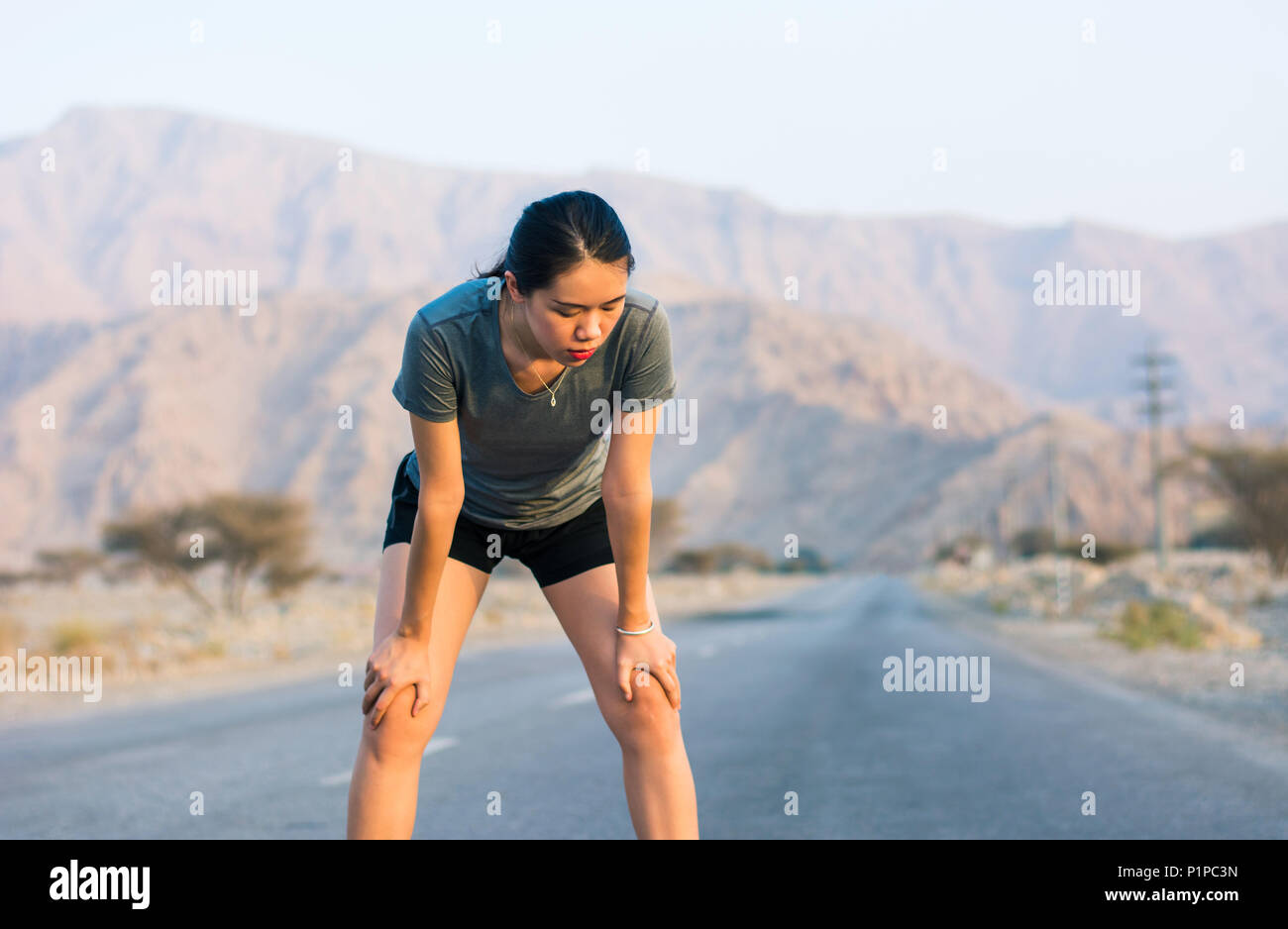 Sporty woman runner run on empty road hi-res stock photography and ...
