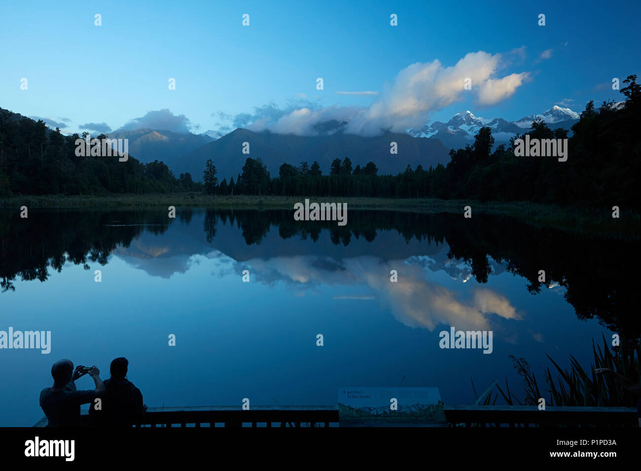 Tourists, and summits of Mt Tasman (left) and Aoraki / Mt Cook (right ...
