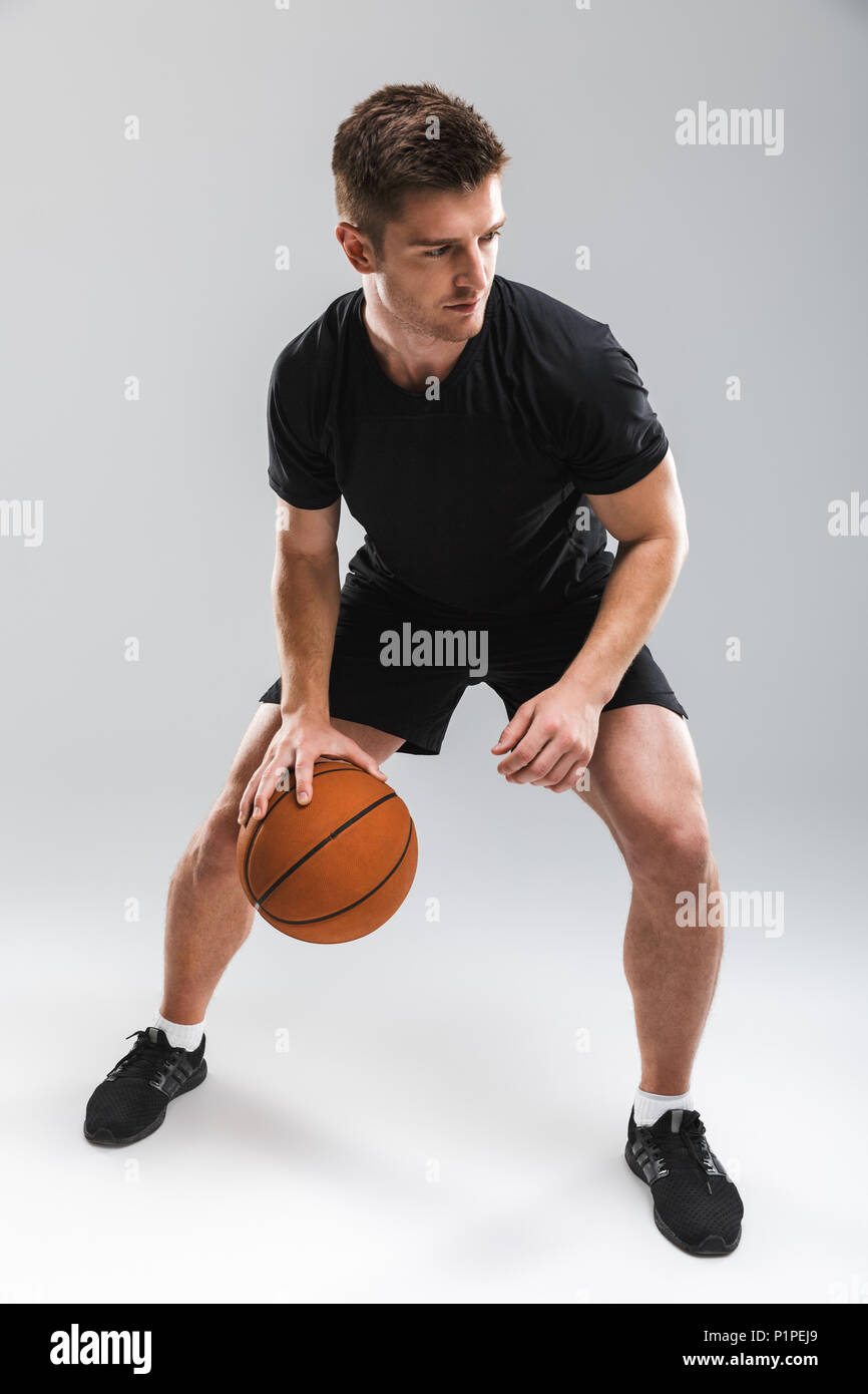 Full length portrait of a concentrated young sportsman playing ...