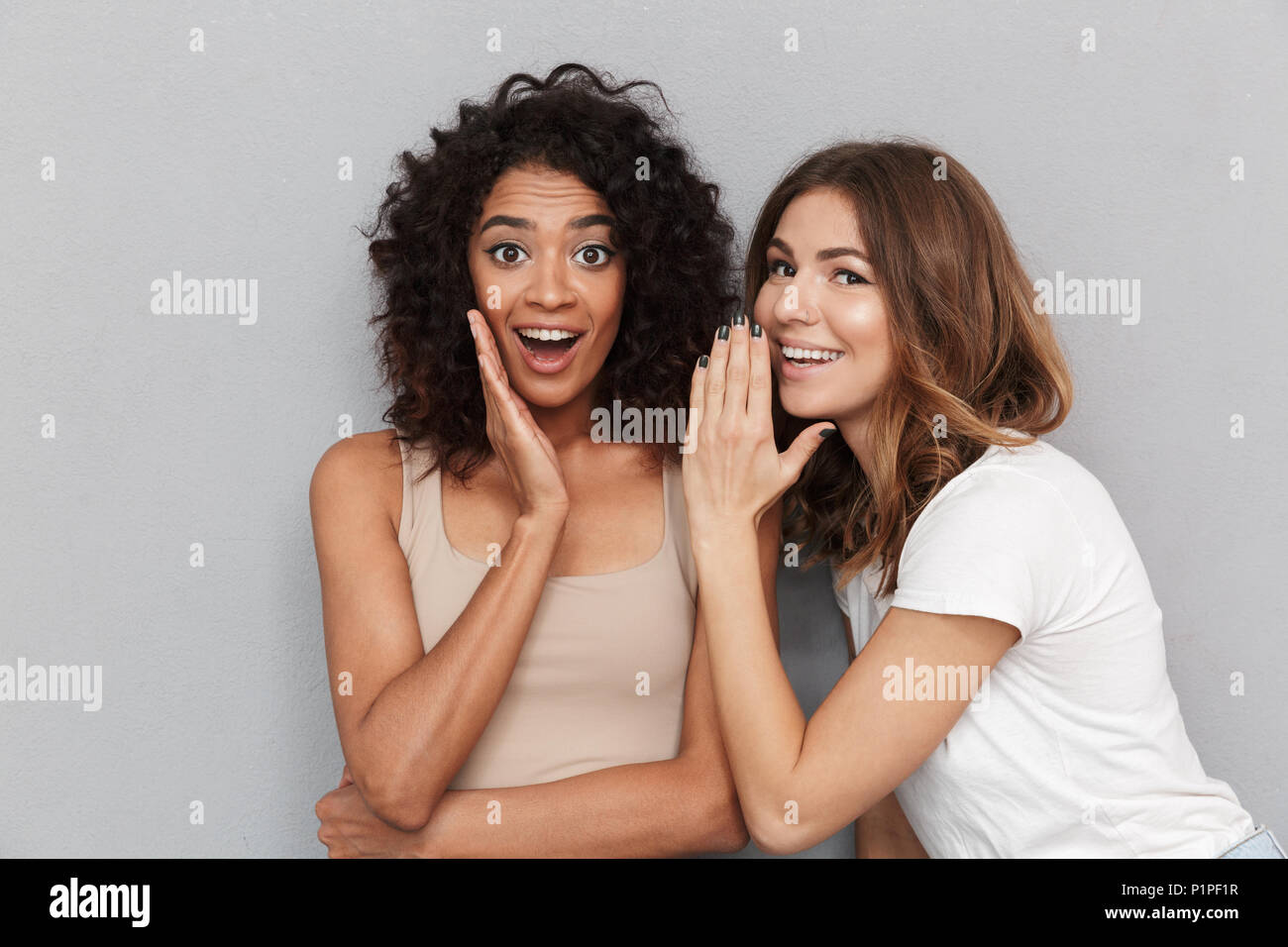 Two women telling secrets hi-res stock photography and images - Alamy